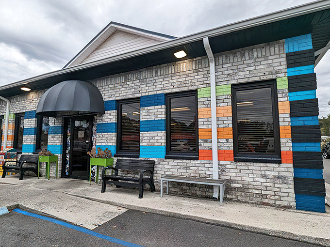 The colorful exterior of Early Bird Diner beckons like a rainbow after a Charleston rainstorm. Those vibrant stripes aren't just decoration—they're a promise of the personality waiting inside.