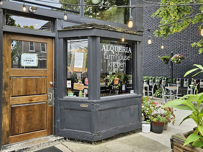 Alqueria's inviting exterior beckons with vibrant flower boxes and a sleek black facade. This farmhouse kitchen feels like Columbus's best-kept secret hiding in plain sight.