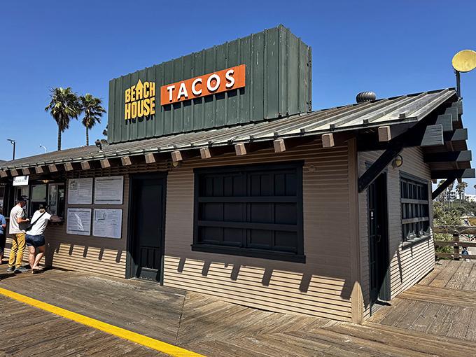 The green shack with the orange sign isn't trying to impress anyone—except your taste buds. California coastal dining at its most authentic.