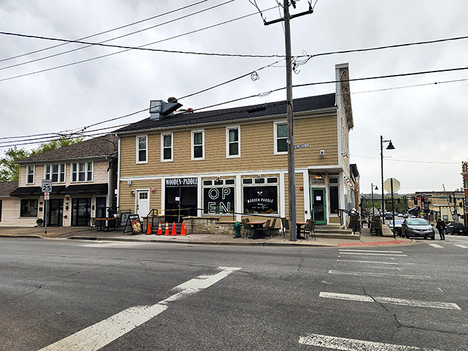 The unassuming yellow exterior of Wooden Paddle hides culinary treasures within, like finding a Michelin-worthy meal in your neighbor's kitchen.