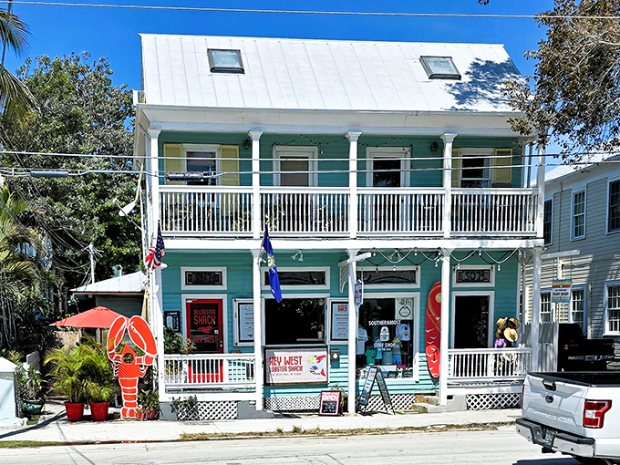 The turquoise charm of The Lobster Shack beckons seafood pilgrims from across Florida. That giant lobster out front isn't just decoration—it's a promise.