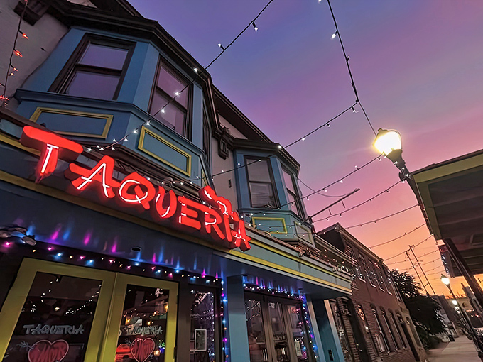 That neon red "TAQUERIA" sign glowing against Philadelphia's twilight sky promises serious flavor adventures ahead.