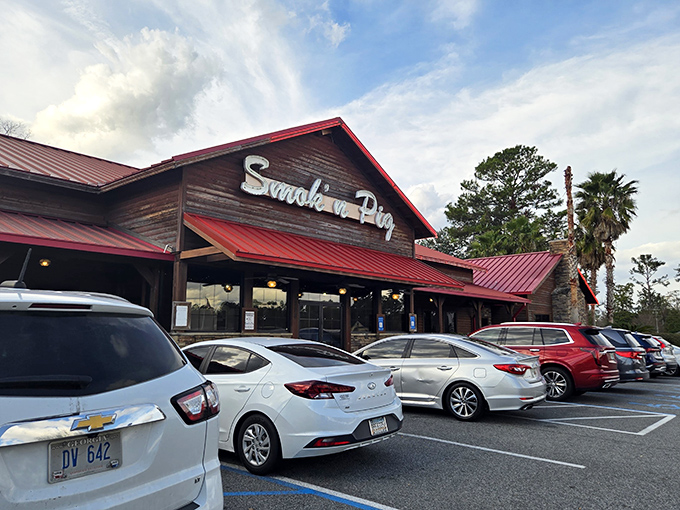 The rustic wooden exterior with its signature red roof isn't just inviting&mdash;it's practically a smoke signal to hungry travelers passing through Valdosta.