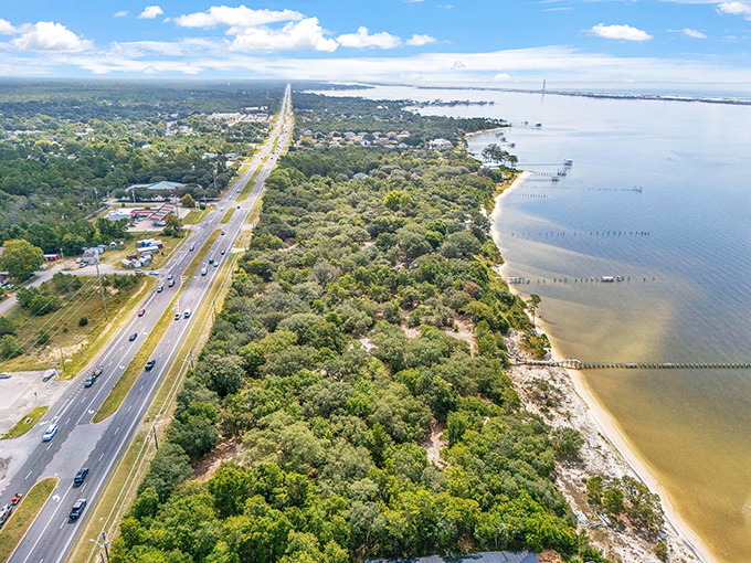 Navarre's lush greenery meets coastal charm in this aerial view, where nature and neighborhoods coexist in perfect Florida harmony.