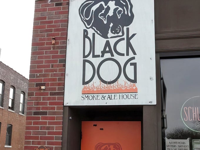 The iconic Black Dog sign beckons like a barbecue lighthouse on Urbana's brick facade. Simple, straightforward, and promising smoky delights within.