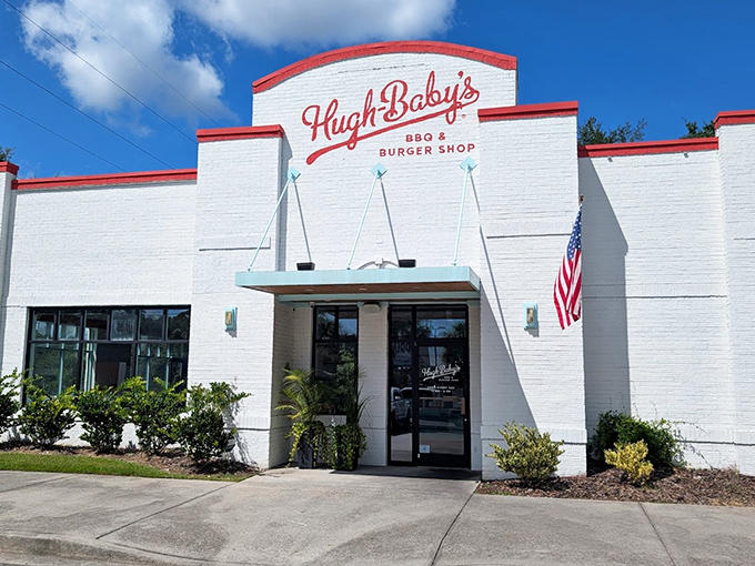The white brick fortress of flavor! Hugh-Baby's crisp exterior with its bold red trim promises burger paradise before you even step inside.