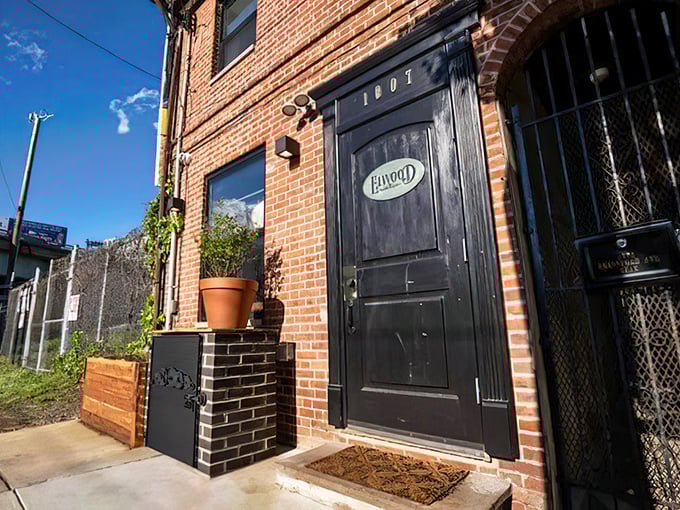 The unassuming entrance to culinary paradise &ndash; a black door with a golden Elwood plaque that promises treasures beyond the brick facade.