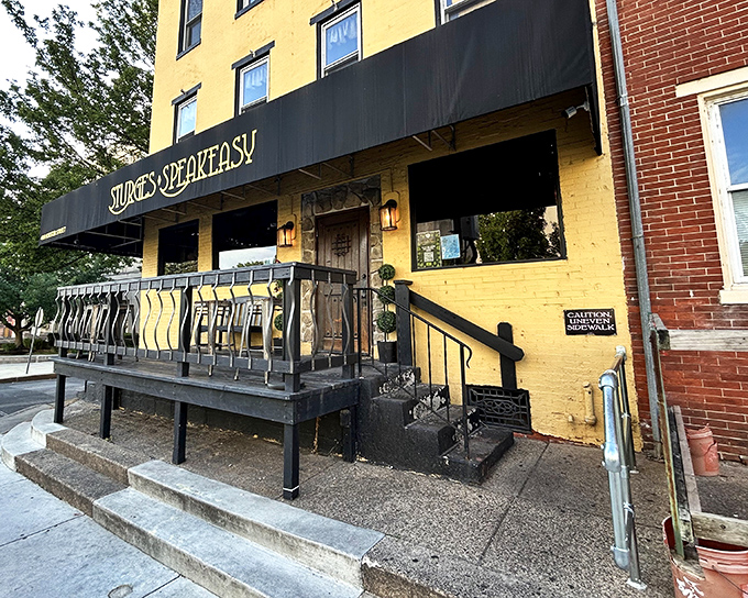 The bright yellow facade of Sturges Speakeasy stands out like a culinary beacon in Harrisburg, promising delicious secrets within rather than illicit hooch.