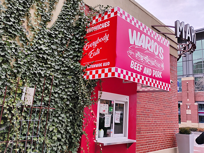 That unmistakable pink-and-red checkered facade isn't just eye-catching—it's a beacon of sandwich salvation nestled against ivy-covered brick on Nationwide Boulevard.