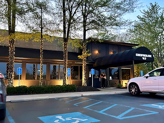 The exterior beckons with twinkling lights wrapped around trees, promising an evening of culinary delight that begins the moment you arrive.