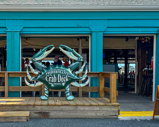 The iconic blue crab sculpture welcomes you to seafood paradise, standing guard like the Chesapeake Bay's unofficial mascot.