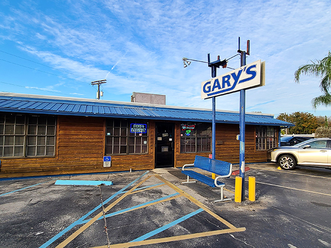 The blue bench outside Gary's isn't just seating—it's the waiting room for some of Florida's finest seafood treasures hiding behind that unassuming wooden facade.