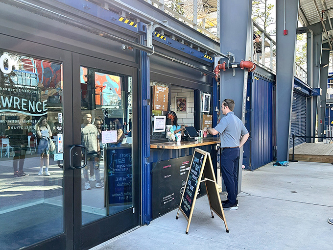 The blue shipping container exterior of Lawrence Barbecue beckons like a siren song for smoke-seekers. Modern design meets traditional BBQ sensibilities.