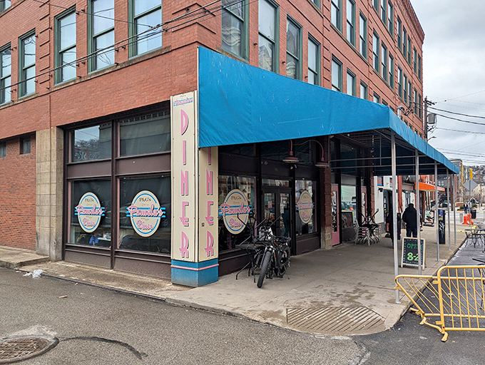 The iconic blue awning of Pamela's Diner in Pittsburgh's Strip District stands as a beacon for breakfast pilgrims seeking crepe-style enlightenment.