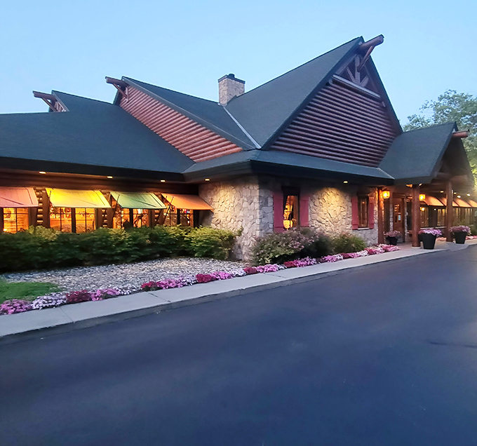 Like a woodland mirage in suburban Michigan, Big Bear Lodge's timber-framed entrance promises rustic comfort before you even step inside.