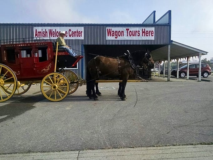 The classic red wagon awaits outside the Amish Welcome Center, where your journey into a simpler time begins with the clip-clop of hooves.