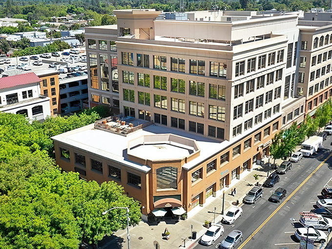 Downtown Modesto at dusk transforms into a postcard-perfect scene, where the historic architecture meets modern charm under the glow of street lamps.