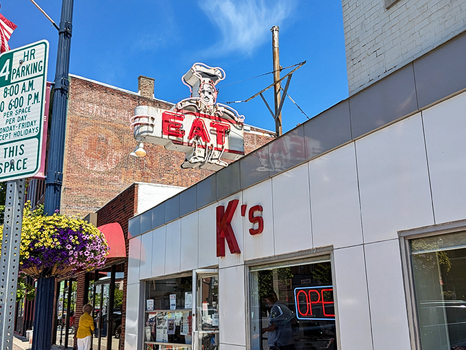 The unassuming white exterior of K's Hamburger Shop in Troy stands as a time capsule of Americana, complete with that classic neon sign that's been beckoning hungry travelers for generations.