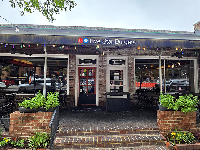 The charming brick exterior of 5 Star Burgers beckons like an old friend with a delicious secret. String lights add that perfect touch of "come on in" warmth.