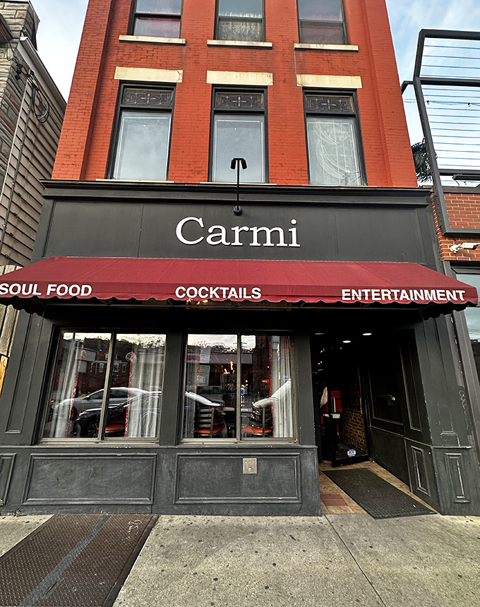 The iconic red awning of Carmi Soul Food beckons hungry travelers like a Southern lighthouse guiding ships to comfort food harbor.