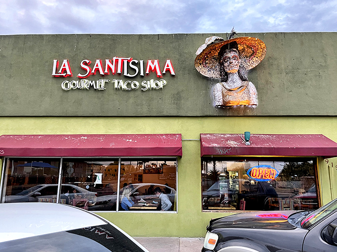 The lime-green exterior of La Santisima stands out like a beacon of taco promise, complete with a folk art figure wearing what might be Arizona's most stylish sombrero.