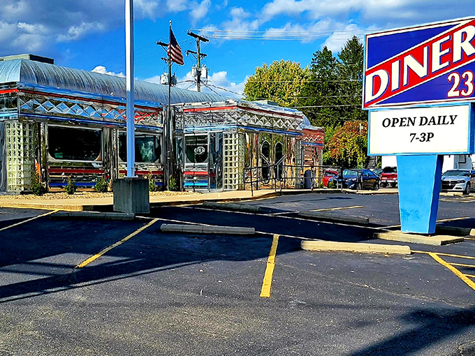 The gleaming stainless steel exterior of Diner 23 stands like a time capsule on wheels, permanently parked in Waverly with an American flag proudly waving hello.