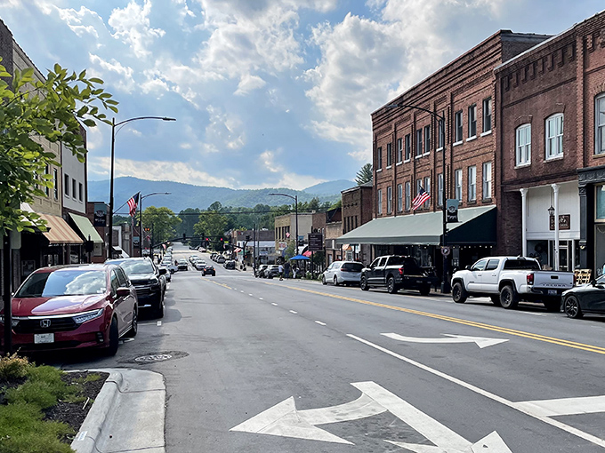 Main Street Brevard stretches toward the Blue Ridge Mountains like a postcard come to life, where brick buildings and mountain views create small-town perfection.