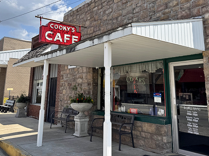 The iconic red sign beckons like a lighthouse for hungry travelers. Cooky's stone exterior promises timeless comfort in Golden City's heart.