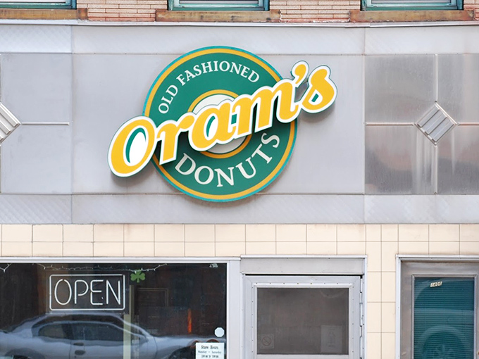 The green and yellow beacon of hope for carb enthusiasts everywhere. Oram's iconic sign promises old-fashioned delights that modern donuts can only dream of becoming.