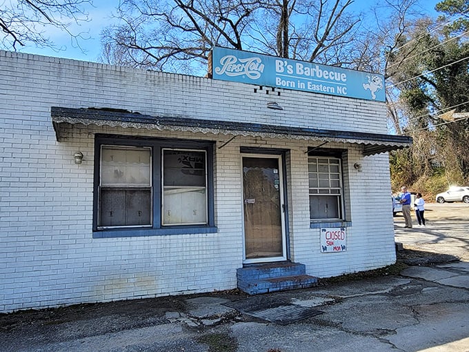 The unassuming white brick exterior of B's Barbecue stands like a barbecue shrine in Greenville, complete with its iconic blue sign declaring Eastern NC roots.
