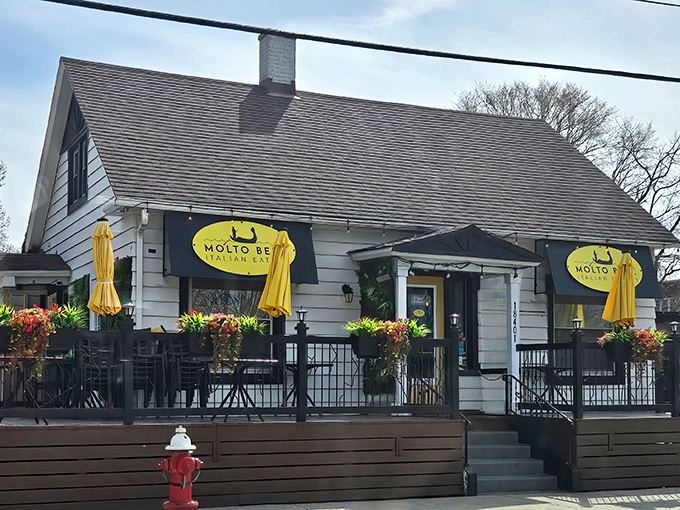 Home is where the pasta is! Molto Bene's charming converted house exterior with sunny yellow awnings promises Italian comfort in suburban Lakewood.