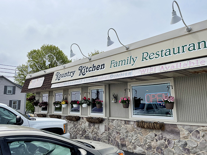 The unassuming exterior of Kountry Kitchen, where hanging flower baskets offer the first hint that someone inside really cares about the details.