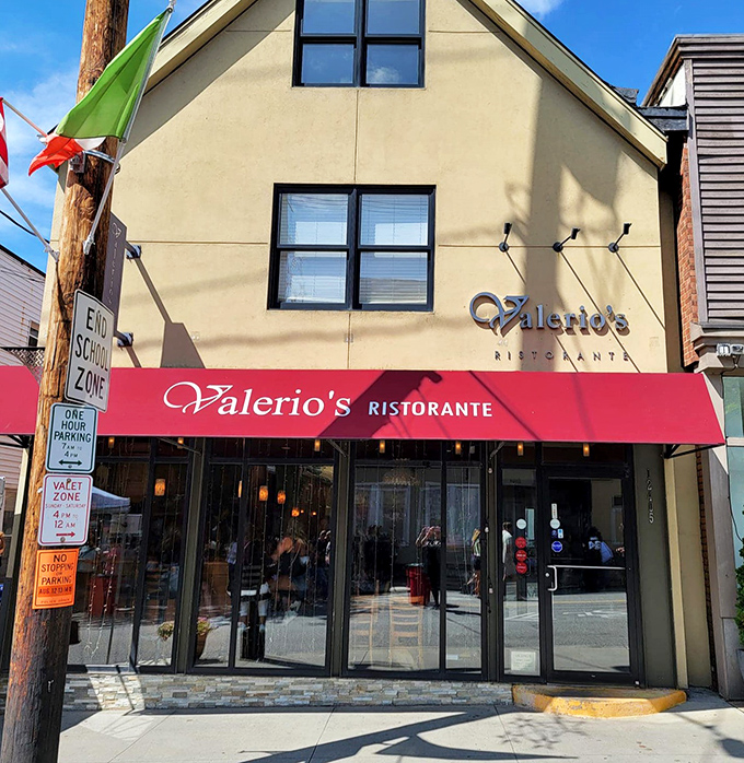 The burgundy awning and warm glow of Valerio's at night&mdash;like a beacon calling all pasta pilgrims home to roost.
