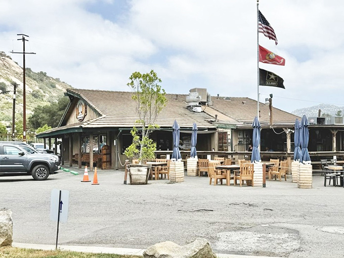 The quintessential California roadhouse beckons with rustic charm, three proud flags, and the promise of comfort food that'll make your soul sing.
