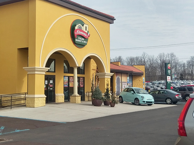 The sunshine-yellow facade of Altomonte's stands like a beacon of culinary promise, complete with a charming red Italian delivery vehicle that practically screams "authenticity awaits inside!"