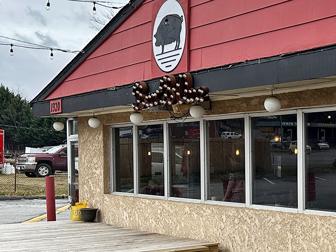 The crimson exterior of Doc Brown's BBQ stands like a beacon of hope for hungry travelers, complete with their iconic pig silhouette promising smoky delights within.
