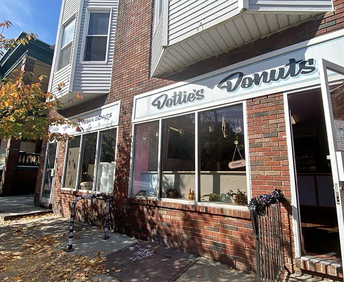 The unassuming brick storefront of Dottie's Donuts in West Philly – where vegan donut dreams come true without a hint of compromise.