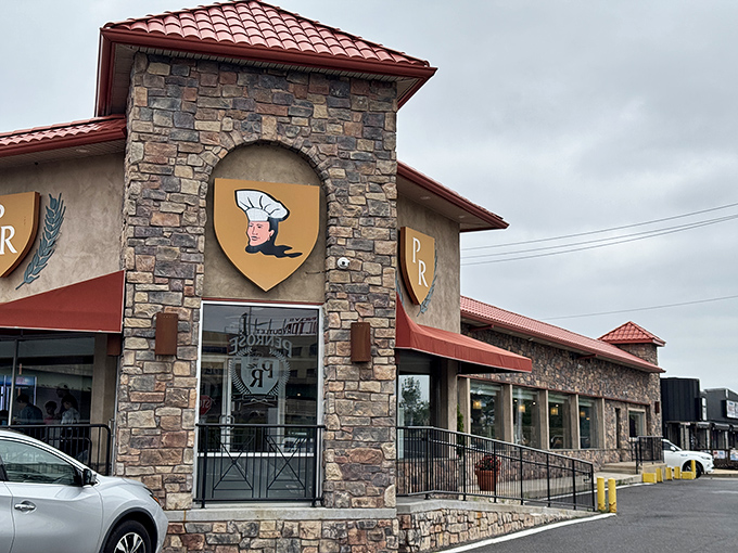 The stone facade and iconic "PR" shield logo of Penrose Diner stands as a beacon of breakfast hope on Penrose Avenue, promising comfort food salvation inside.