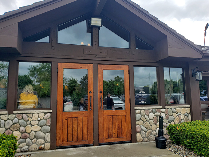 The rustic stone and timber exterior of Alibi of Troy beckons like a cozy northern Michigan lodge that somehow landed in the suburbs.