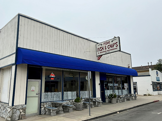 The unassuming exterior of Pismo Fish & Chips stands like a culinary lighthouse on the California coast, its blue awning a beacon for seafood lovers.