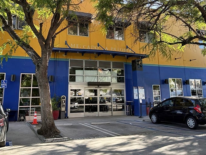 The vibrant blue and yellow exterior of Holbox stands out like a tropical island paradise in urban Los Angeles, complete with a line of eager seafood pilgrims.