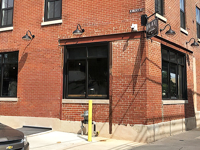 The unassuming entrance to poultry paradise. That circular sign promises more flavor per square inch than most five-star restaurants deliver in an entire meal.