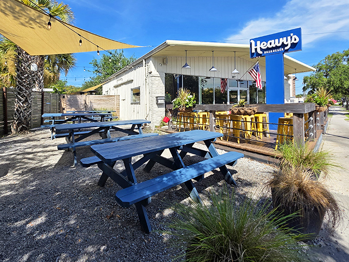 The blue sign beckons like a lighthouse for hungry souls. Heavy's modest exterior hides Charleston's burger paradise behind its unassuming facade.
