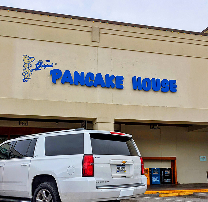 The blue sign beckons like a breakfast lighthouse, guiding hungry souls to pancake paradise in Columbia's bustling shopping center.