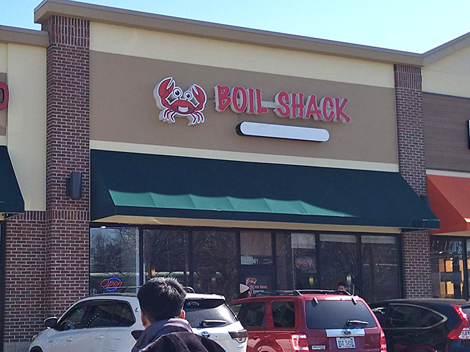 The bright red Boil Shack sign with its cheerful crab logo stands as a beacon for seafood lovers in Toledo. No fancy frills, just a promise of oceanic treasures within.