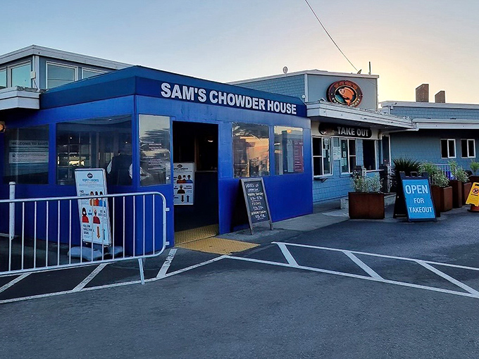 The iconic blue exterior of Sam's Chowder House glows at dusk, a beacon for seafood lovers along the Half Moon Bay coastline.