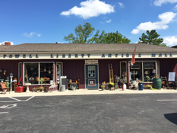 The unassuming burgundy exterior of Powell Liberty Antique Mall promises treasures within, like a vintage jewelry box waiting to be opened.