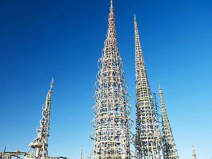 Reaching skyward like metallic giants playing freeze tag with the clouds, these remarkable spires showcase Simon Rodia's visionary craftsmanship at its finest.