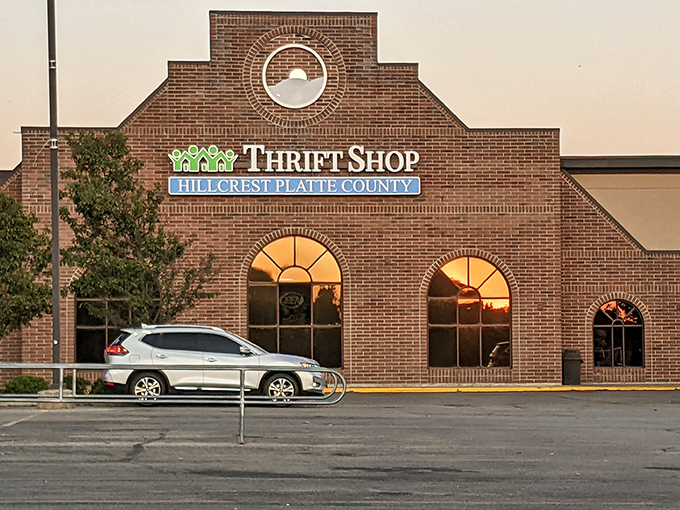 The stately brick facade of Hillcrest Thrift Shop stands like a cathedral of bargains, its arched windows promising treasures within.