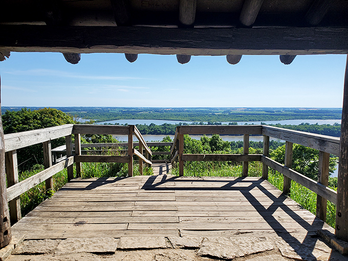 Nature's balcony awaits! From this rustic overlook, the mighty Mississippi and Illinois Rivers converge in a view that makes smartphone cameras weep with inadequacy.